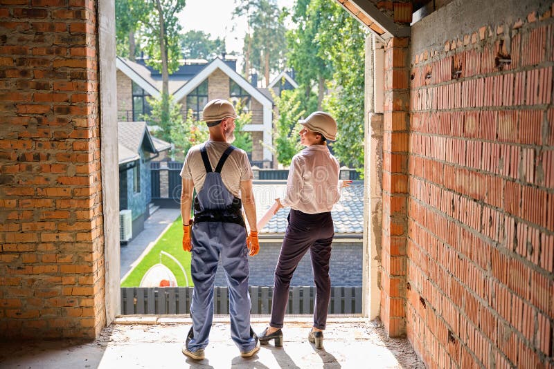 Smiling Project Manager Inspecting Together with Contractor Building ...