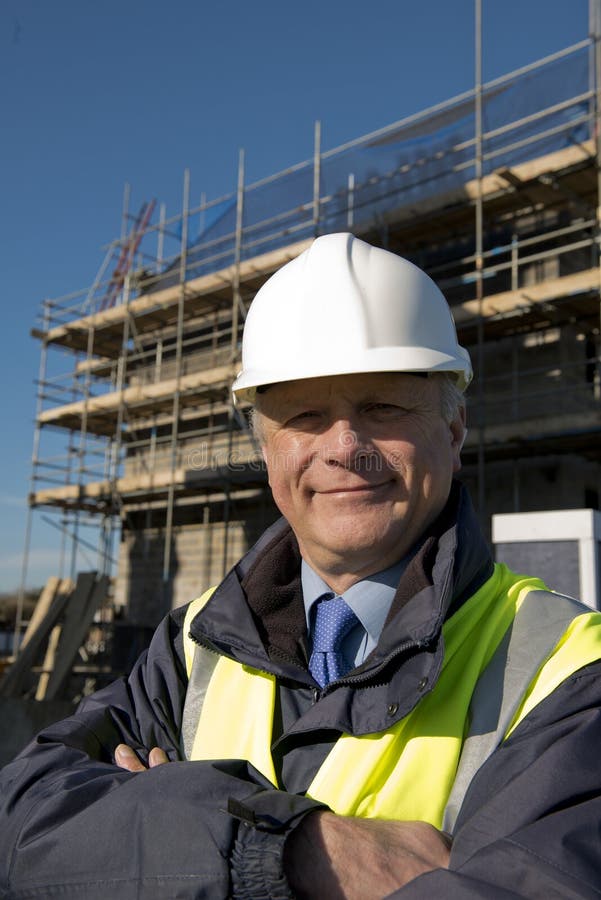 Smiling Property Developer / Building in Front of Construction Site ...