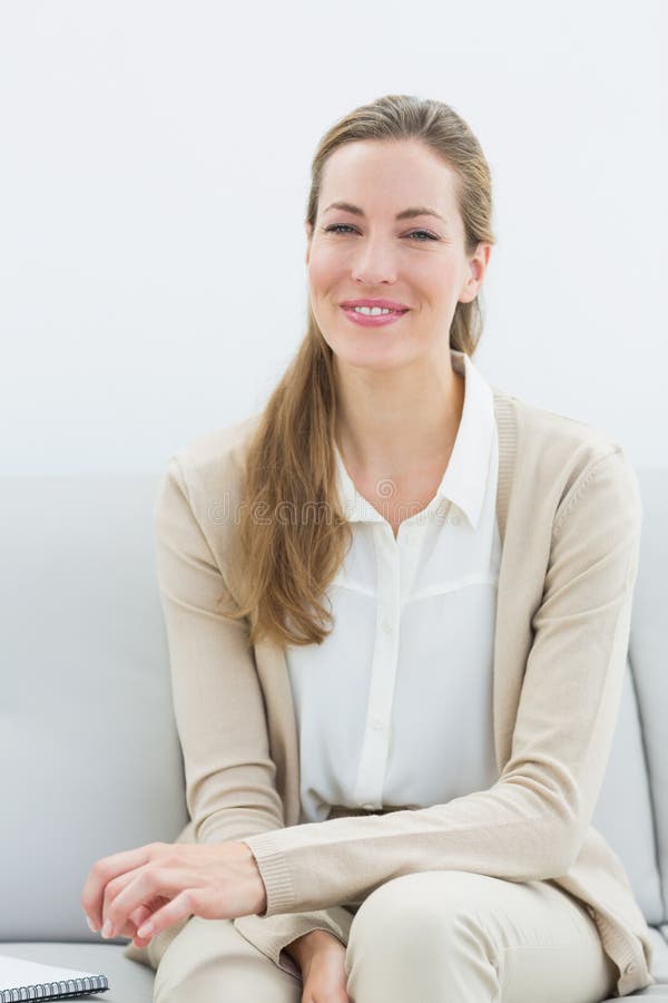 Smiling Female Psychologist Sitting on Sofa Stock Photo - Image of ...
