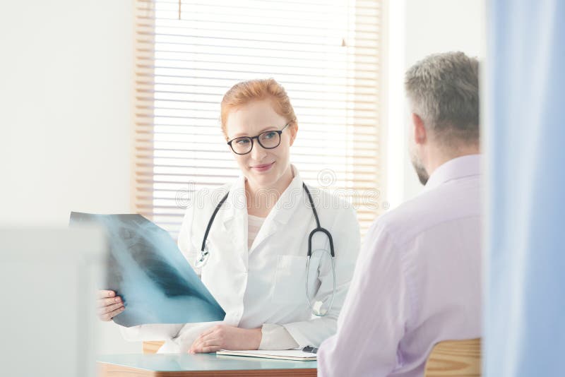 Female Pulmonologist Doctor during the Medical Examination. she Listens ...