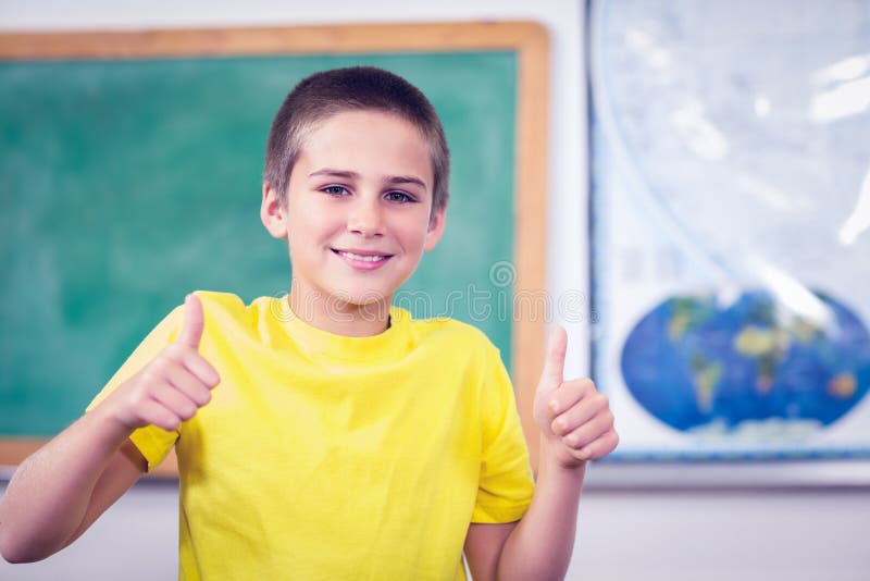 Smiling Pupil Doing Thumbs Up in a Classroom Stock Image - Image of ...