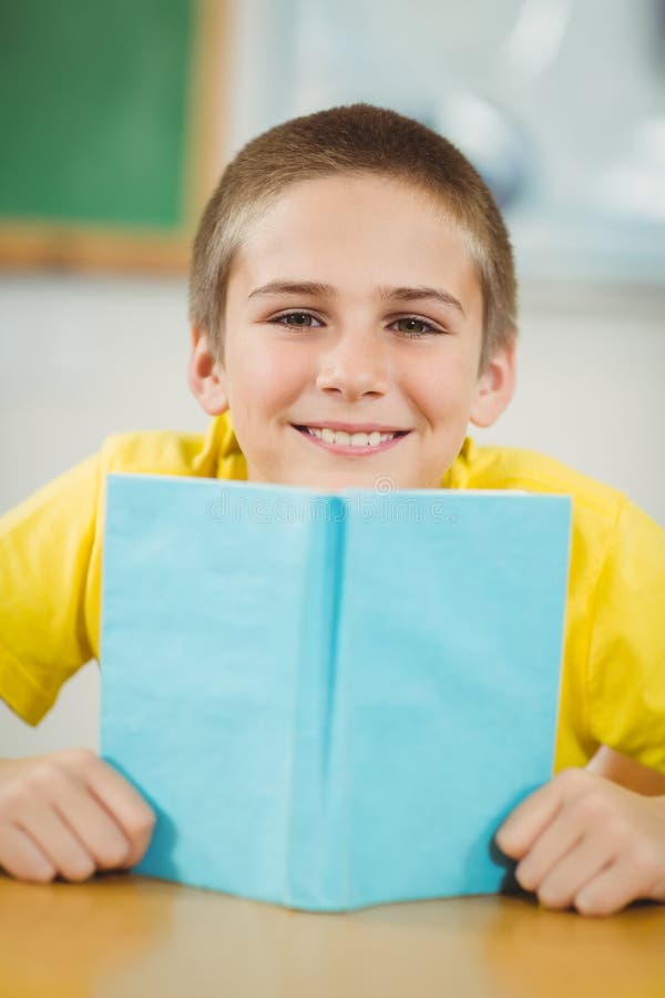 Smiling Pupil Reading Book in a Classroom Stock Image - Image of ...