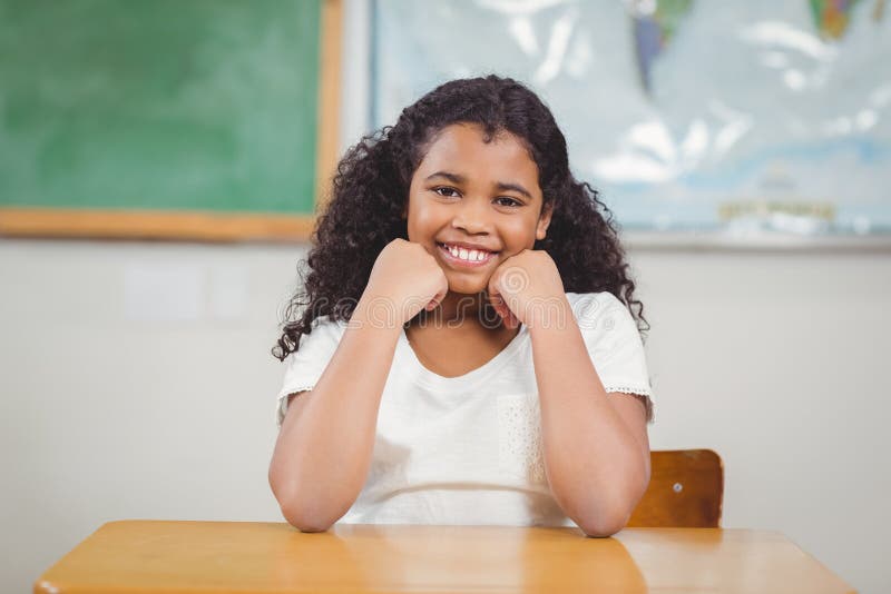 Smiling Pupil Sitting in a Classroom Stock Photo - Image of indoors ...