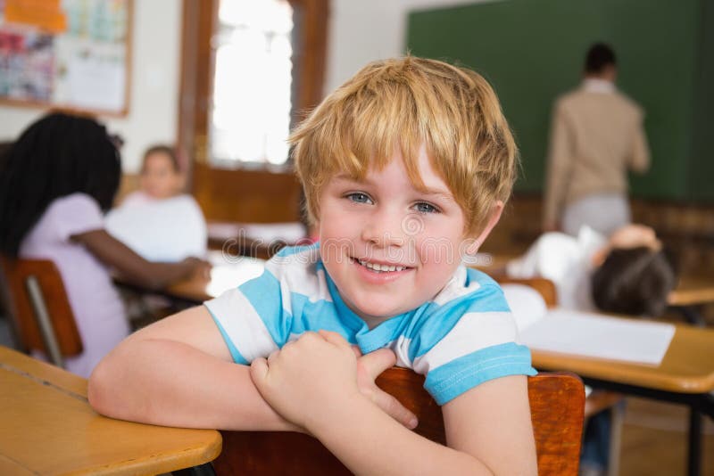 Smiling Pupil Sitting at His Desk Stock Image - Image of looking ...