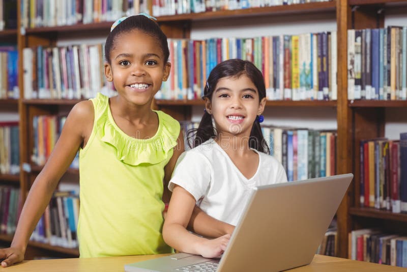 Smiling Pupils Using Laptop in the Library Stock Photo - Image of happy ...