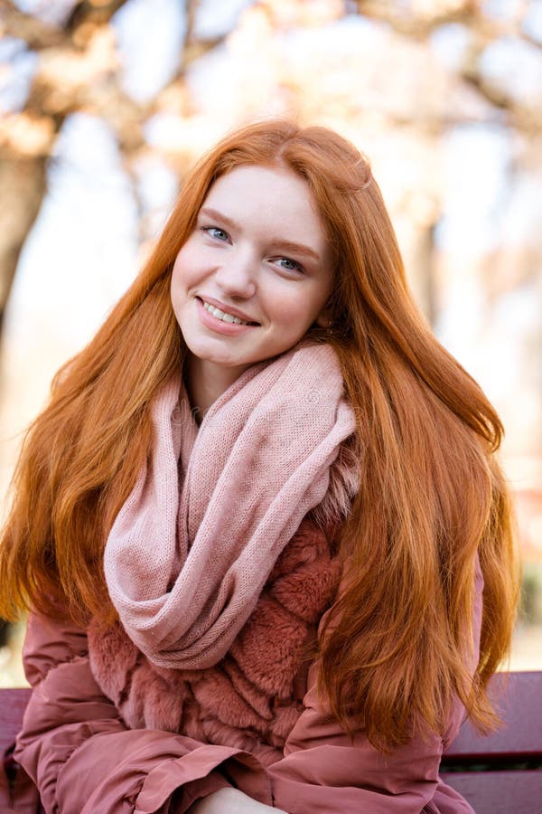 Smiling Redhead Woman Sitting On The Bench Outdoors Stock Image Image