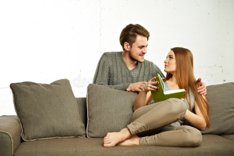 Smiling Romantic Couple With Book Talking On Sofa Stock Image Image