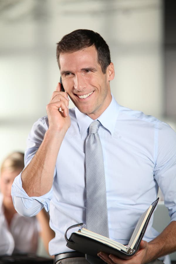 Smiling salesman stock photo. Image of cellphone, smiling - 16561284