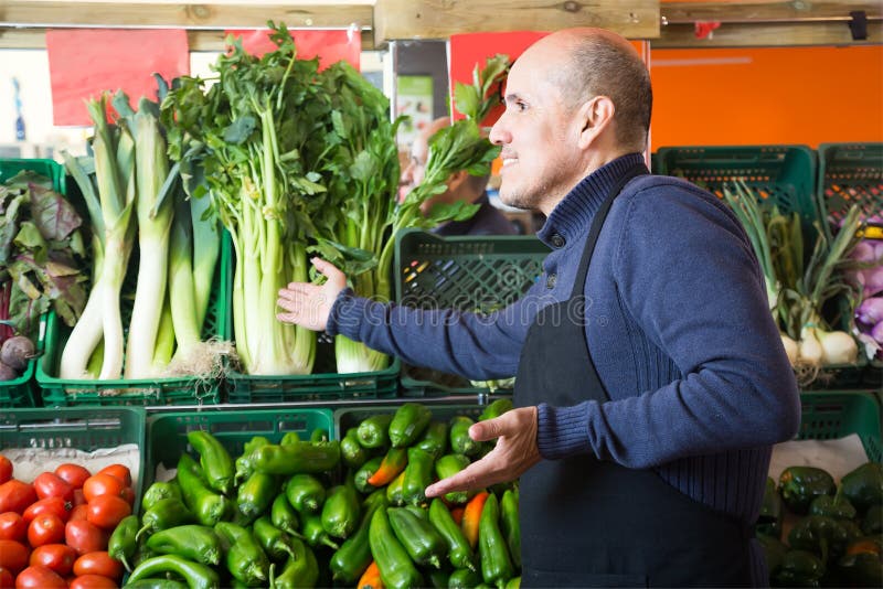 Smiling Salesman Offering Pepper in Vegetable Department Stock Image ...