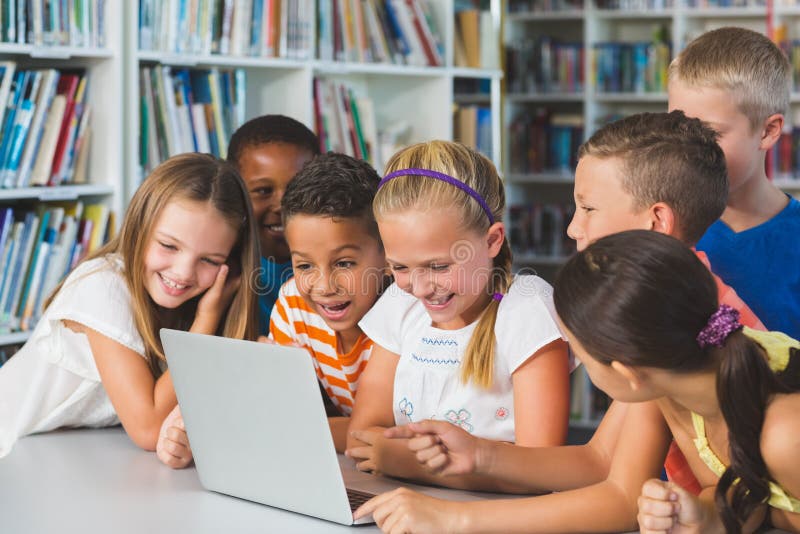 Smiling School Kids Looking at Laptop in Library Stock Image - Image of ...