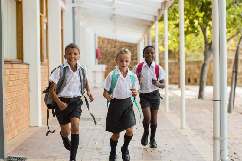 Smiling School Kids Running In Corridor Stock Image - Image of black ...