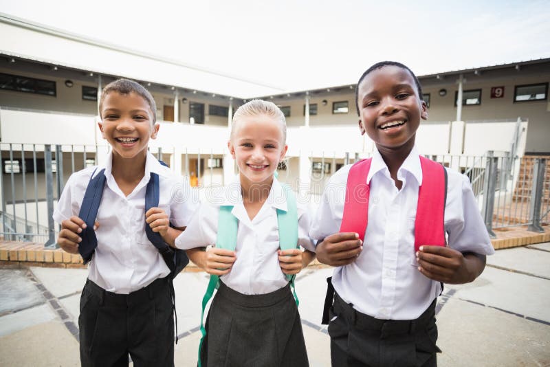 Smiling School Kids Looking at Laptop in Library Stock Image - Image of ...