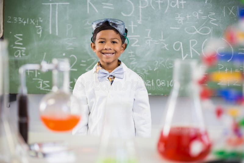Smiling Schoolboy Standing in Classroom with Chemical Flask in ...