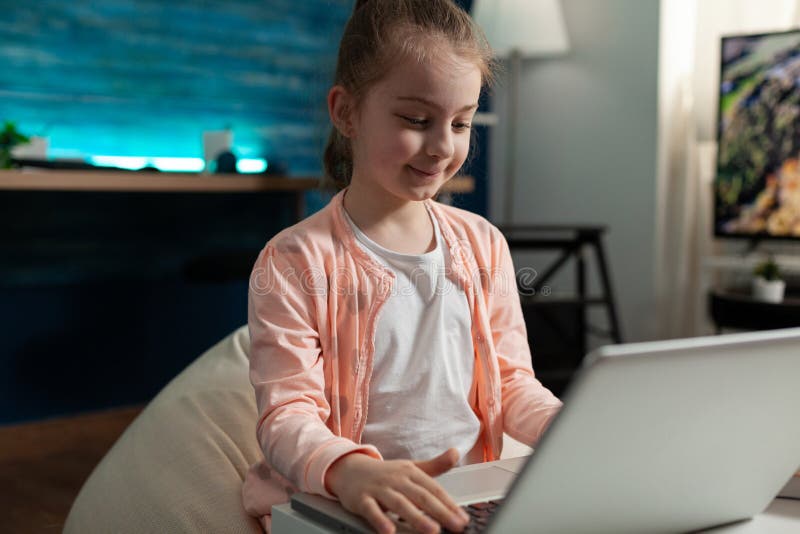 Smiling Schoolchild Browsing Information on Laptop Working at School ...