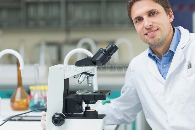 Smiling Scientific Researcher with Microscope in Laboratory Stock Image ...