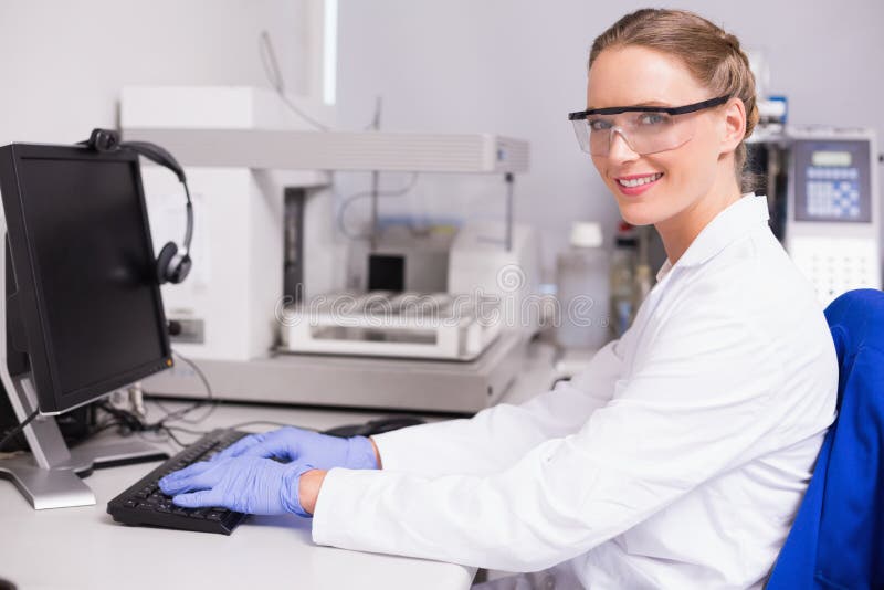 Smiling Scientist Looking at Camera and Using Computer Stock Photo ...