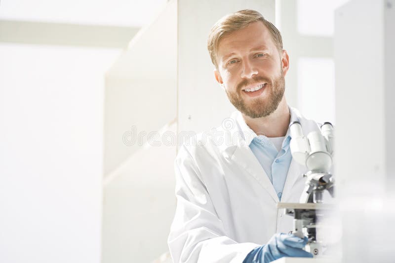 Smiling Scientist Sitting at a Laboratory Table. Stock Photo - Image of ...