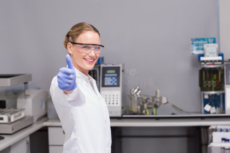 Female Scientist Giving Thumbs Up in Lab with Instruments Wearing Lab ...