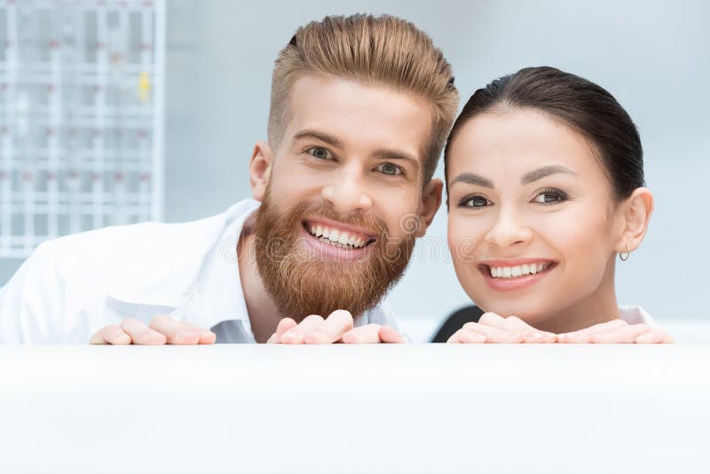 Smiling Scientists Looking Out Behind Table in Lab Stock Photo - Image ...
