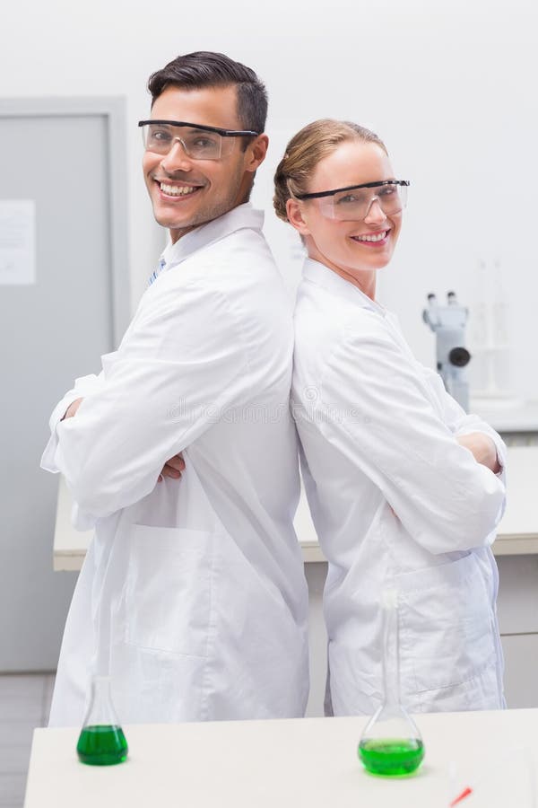 Smiling Scientists Standing Back To Back Stock Photo - Image of ...