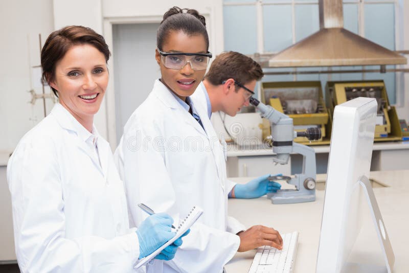 Smiling Scientists Working Together Stock Image - Image of indoors ...