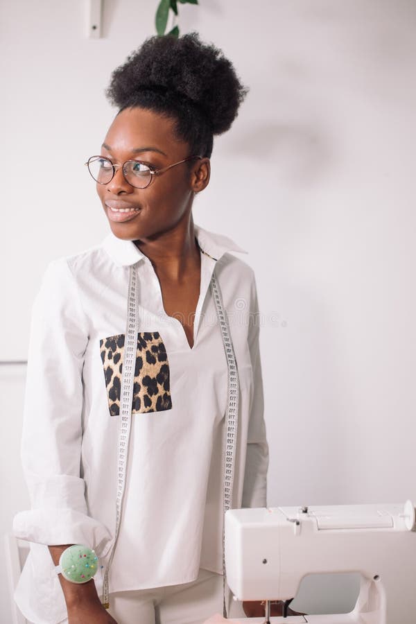 Smiling Seamstress Looking at Camera with Sewing Machine Stock Image ...