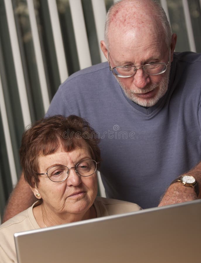 Smiling Senior Adult Couple Having Fun on the Computer Stock Image ...