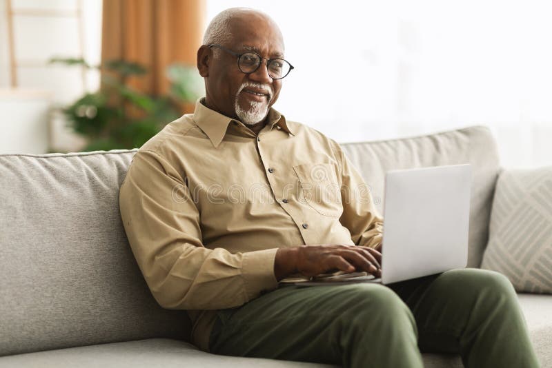 Smiling Senior Black Man Using Laptop Computer at Home Stock Image ...