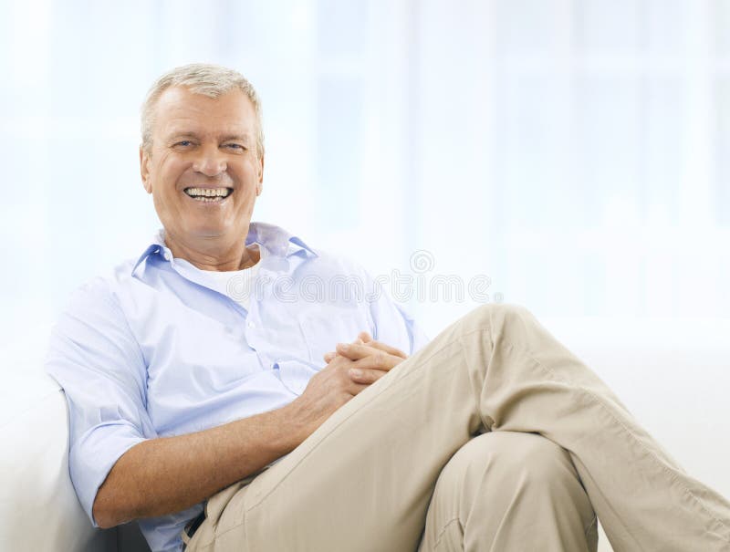 Smiling Senior Man on Couch Stock Image - Image of individuality ...
