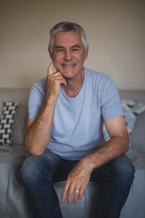 Smiling Senior Man Sitting on Sofa at Home Stock Photo - Image of home ...