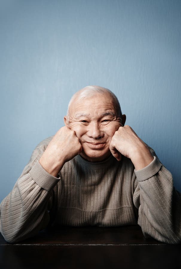 Smiling Senior Man Sitting at the Table and Looking at Camera Stock ...