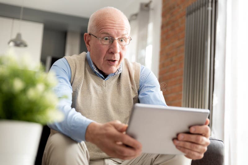Confused Senior Man Using a Digital Tablet Stock Photo - Image of ...