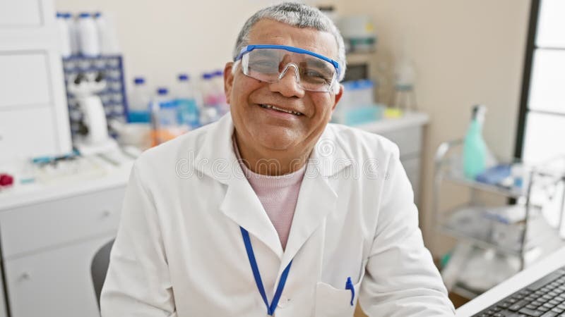 Smiling Senior Scientist in White Lab Coat with Safety Goggles Working ...