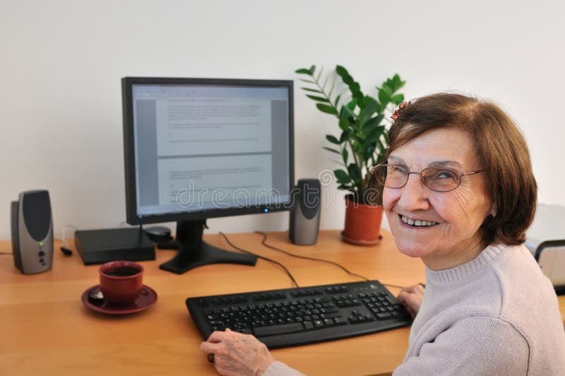 Smiling Senior Woman at Computer Stock Photo - Image of cheerful, aging ...