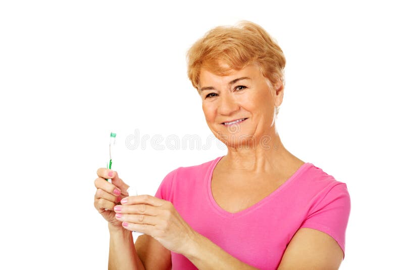 Smiling Senior Woman Holding Toothpaste and Toothbrush Stock Image ...