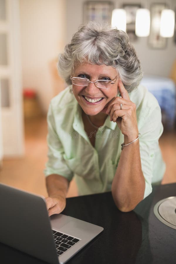 Smiling Senior Woman Using Laptop at Home Stock Photo - Image of laptop ...