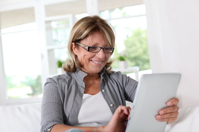 Smiling Senior Woman Using Tablet Stock Photo - Image of modern ...