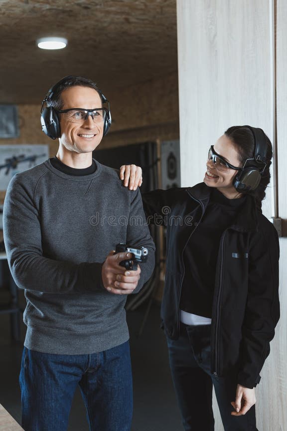 Smiling Shooting Instructor Supporting Client Stock Photo - Image of ...