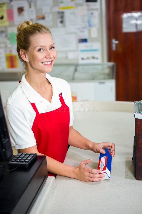Smiling Shop Assistant Offering the Juice at the Counter Stock Photo ...