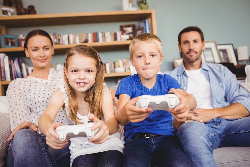 Smiling Siblings Playing Video Games with Parents Stock Image - Image ...