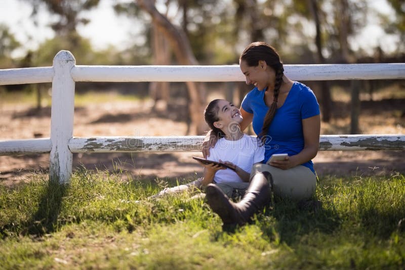 Smiling Siblings Talking while Holding Technologies Stock Image - Image ...