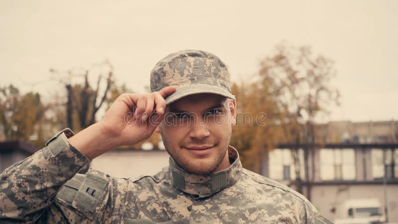 Smiling Soldier in Uniform Adjusting Cap Stock Photo - Image of ...
