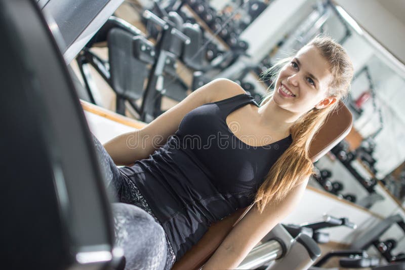 Smiling Sporty Girl Working Out on Exercise Machine in Gym Stock Image ...