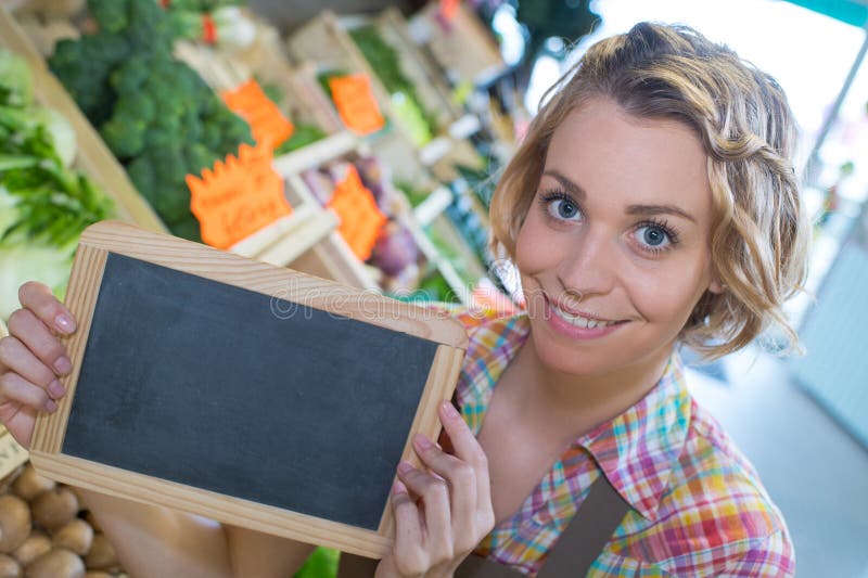 Smiling Staff Holding Organic Sign Board in Organic Section Stock Photo ...