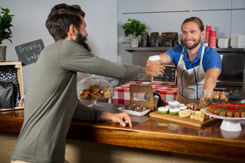Smiling Staff Serving Coffee Cup at Counter Stock Image - Image of ...