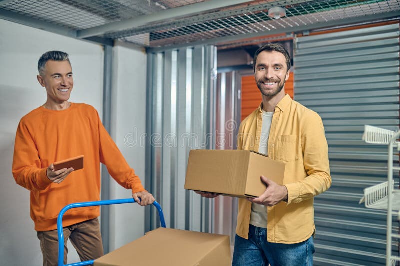 Two Warehouse Workers Standing in the Storage Room Stock Photo - Image ...