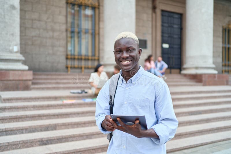 Smiling Student with Digital Tablet Standing in Front of University ...