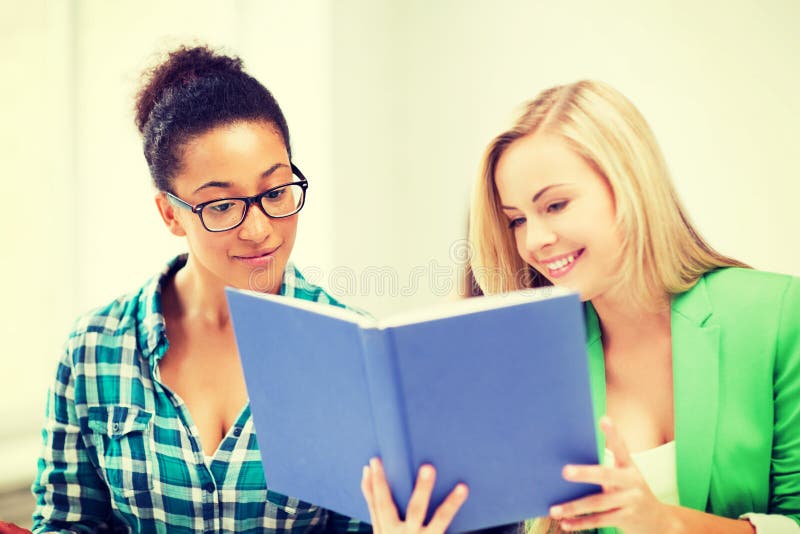 Smiling Student Girls Reading Book at School Stock Image - Image of ...