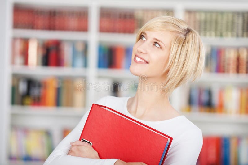 Smiling Student Holding Binder in Library Stock Image - Image of focus ...