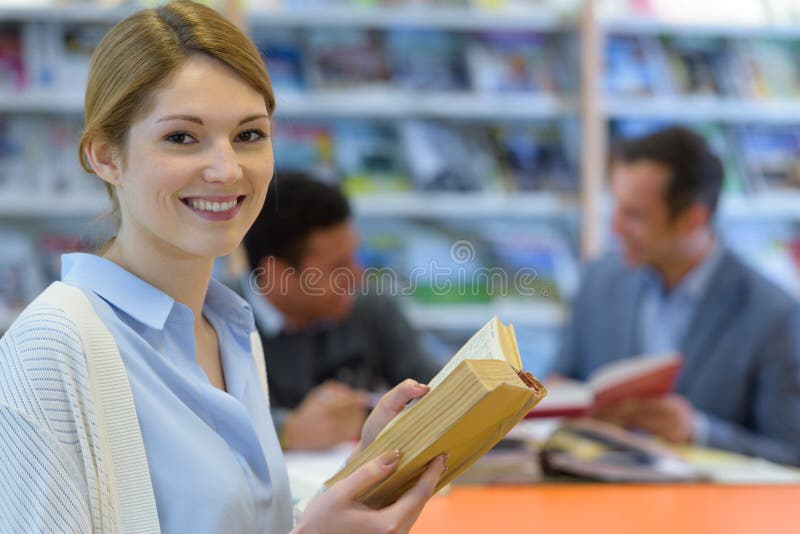 Smiling Student Reading Book in Library Stock Image - Image of ...